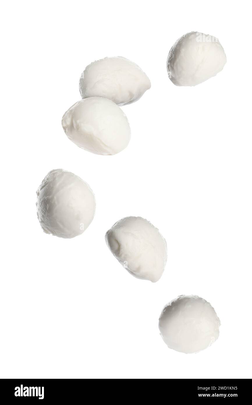 Fresh mozzarella balls falling on white background Stock Photo - Alamy