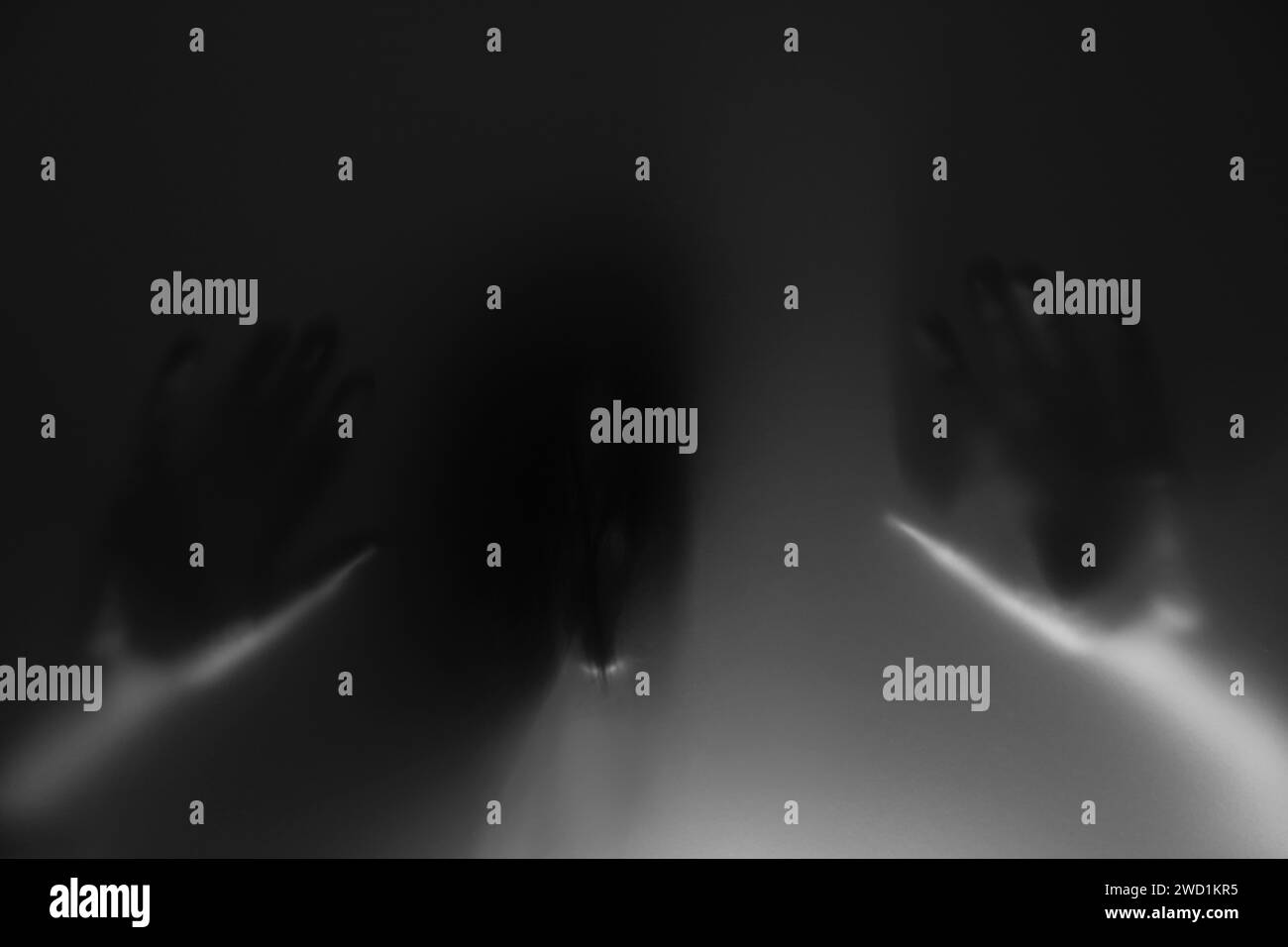 Silhouette of creepy ghost behind glass against grey background Stock ...