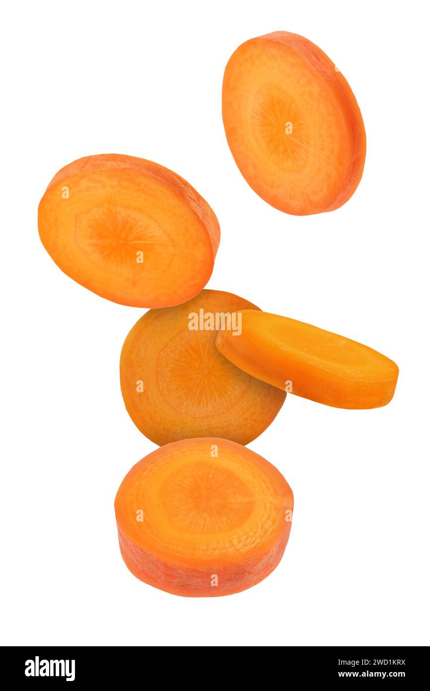Fresh carrot slices falling on white background Stock Photo - Alamy