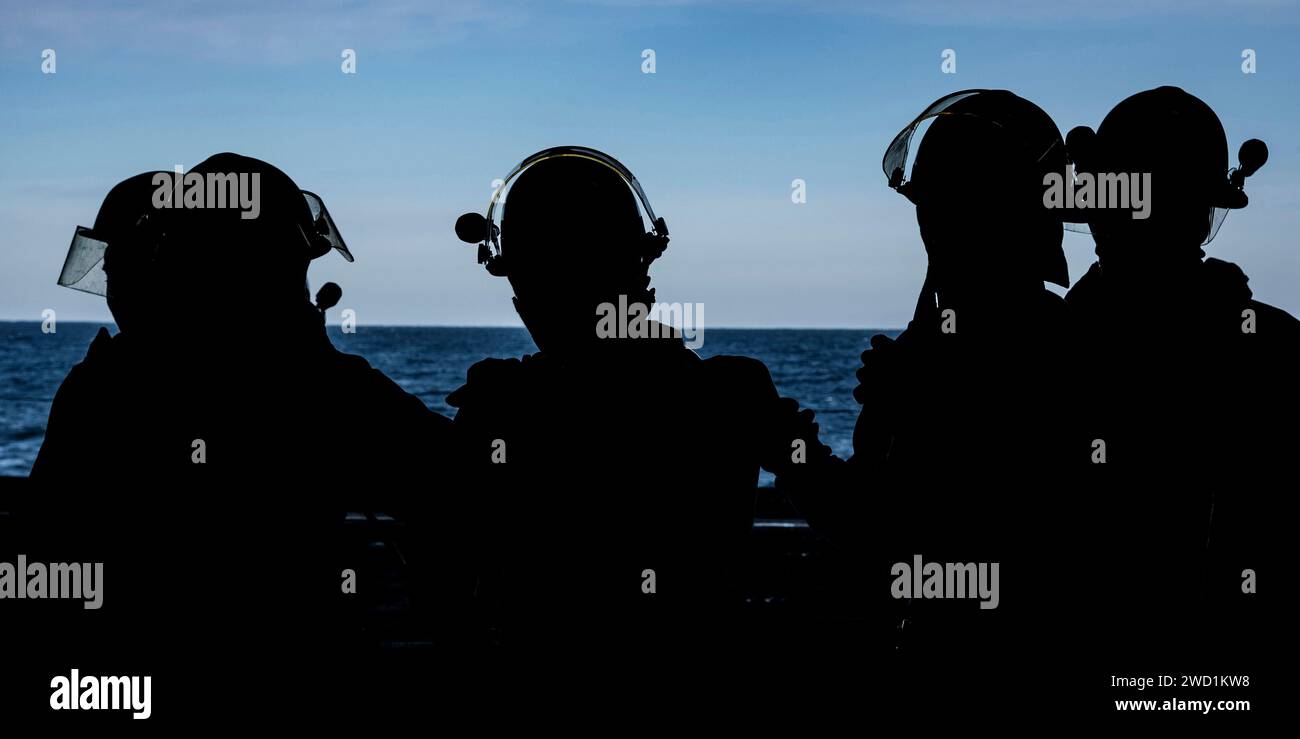 Sailors standby on the fantail of the aircraft carrier USS Dwight D ...
