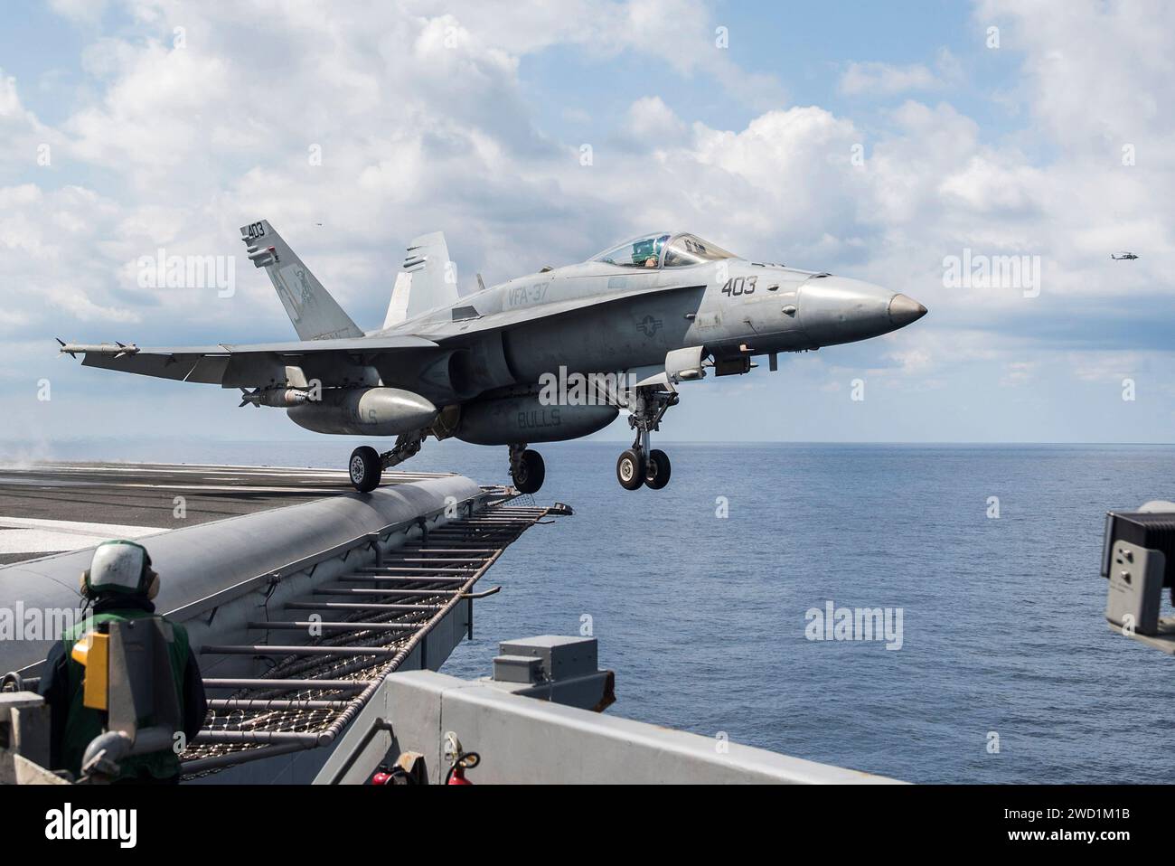 An F/A-18C Hornet launches from the flight deck of the aircraft carrier ...