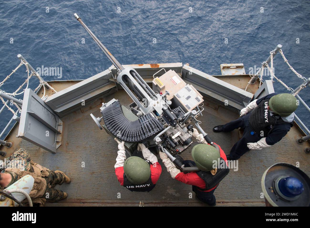 Gunner's Mate fires a Mark 38 Mod-1 machine gun aboard USS Bonhomme ...