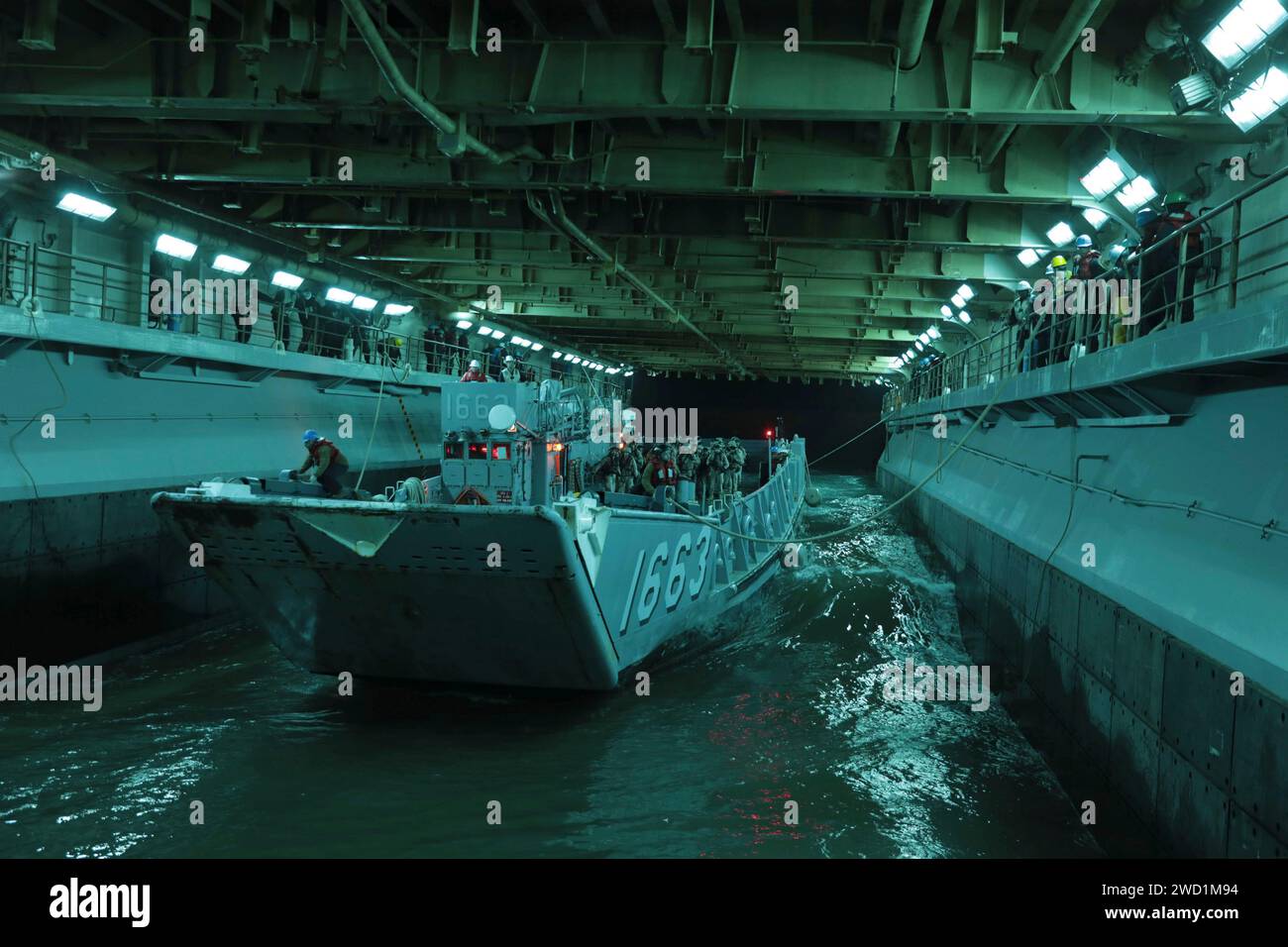 A landing craft utility pulls into the well deck of the amphibious ...