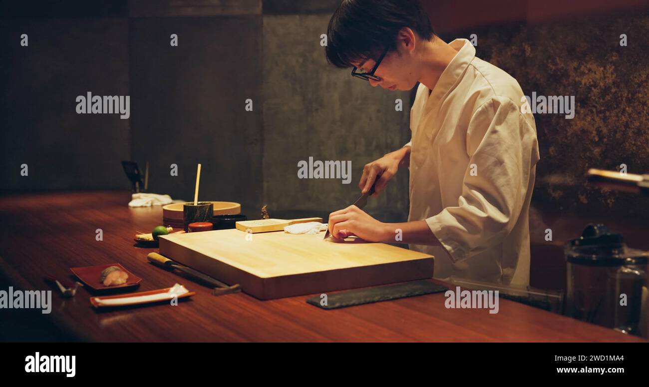 Japan chef, restaurant and cutting fish for sushi, glasses and ...