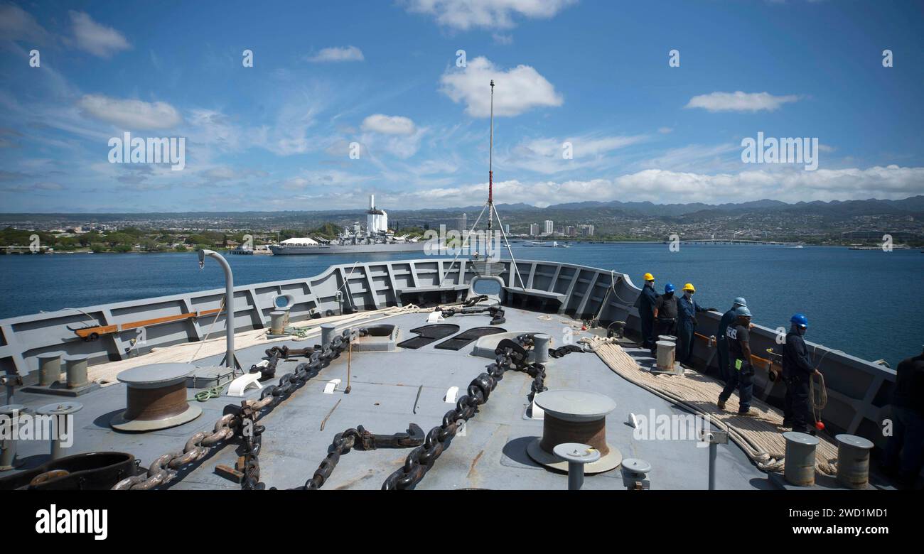 Sailors aboard teh submarine tender USS Frank Cable prepare to throw ...