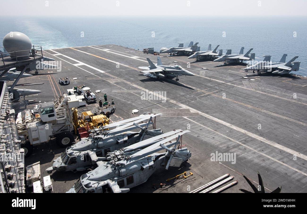 An F/A-18C Hornet lands aboard the aircraft carrier USS George H.W ...