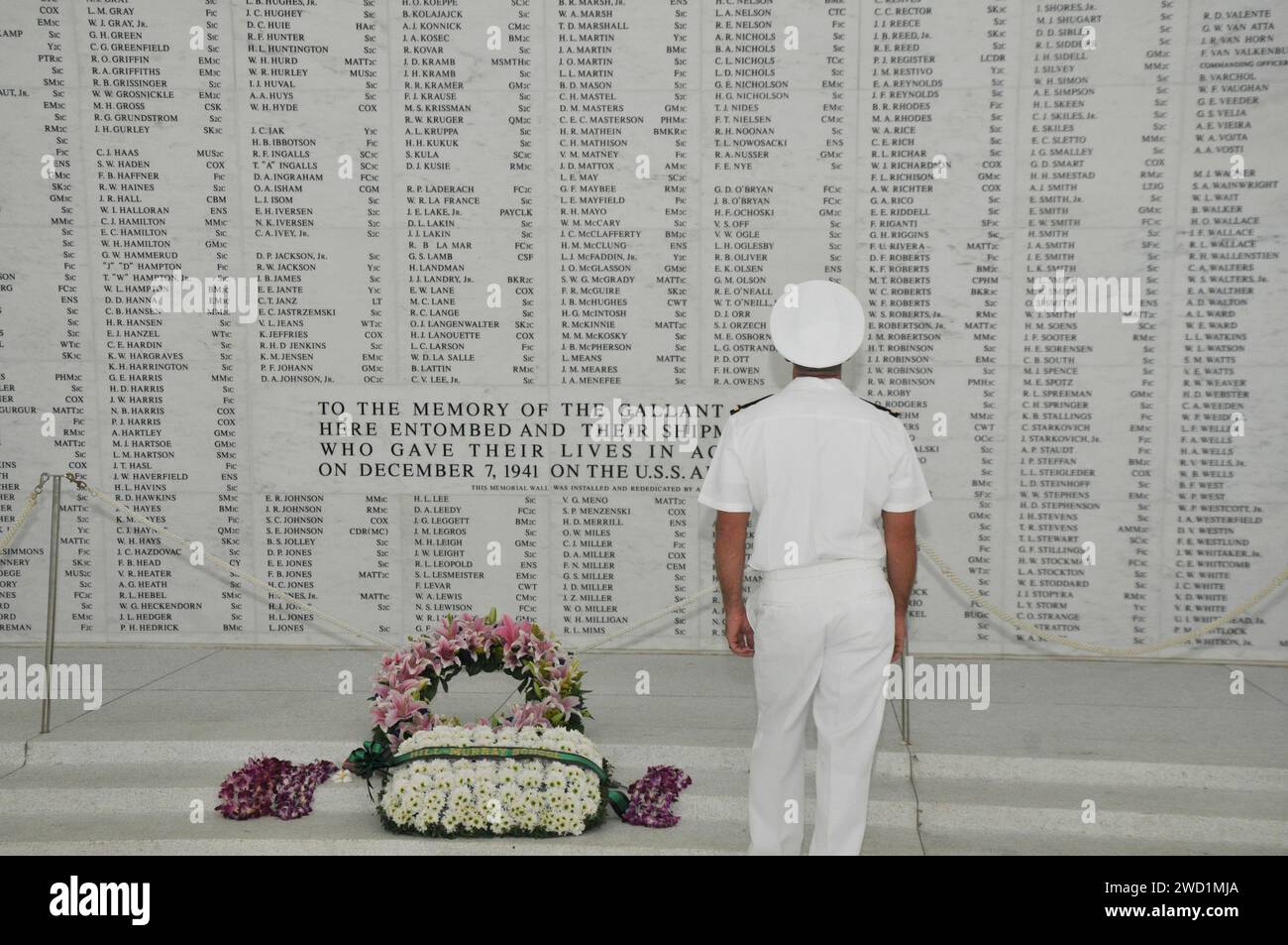 A sailor pays his respects to the fallen at the USS Arizona memorial ...