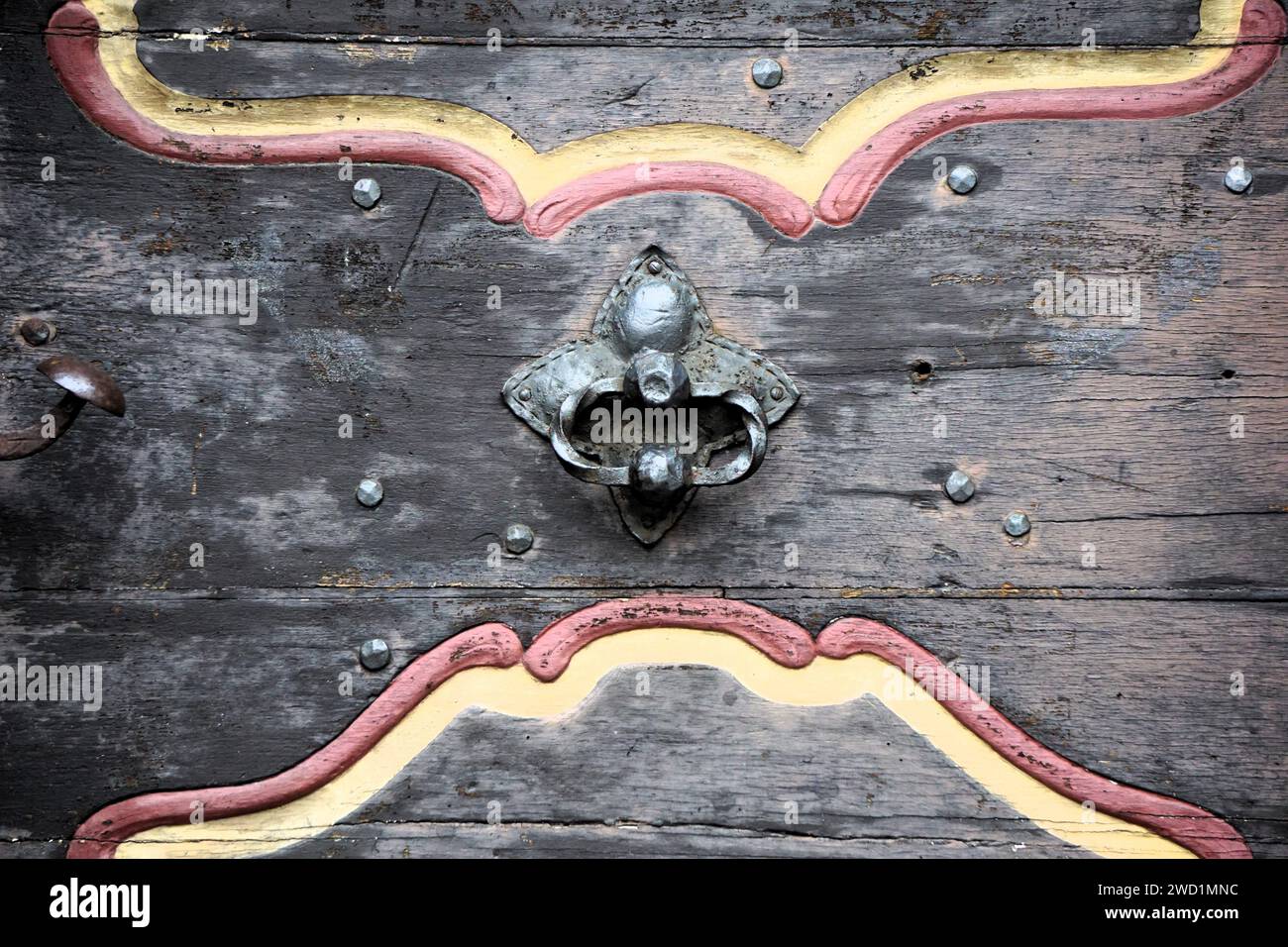 A metal handle and knob adorn a door, surrounded by various objects in ...