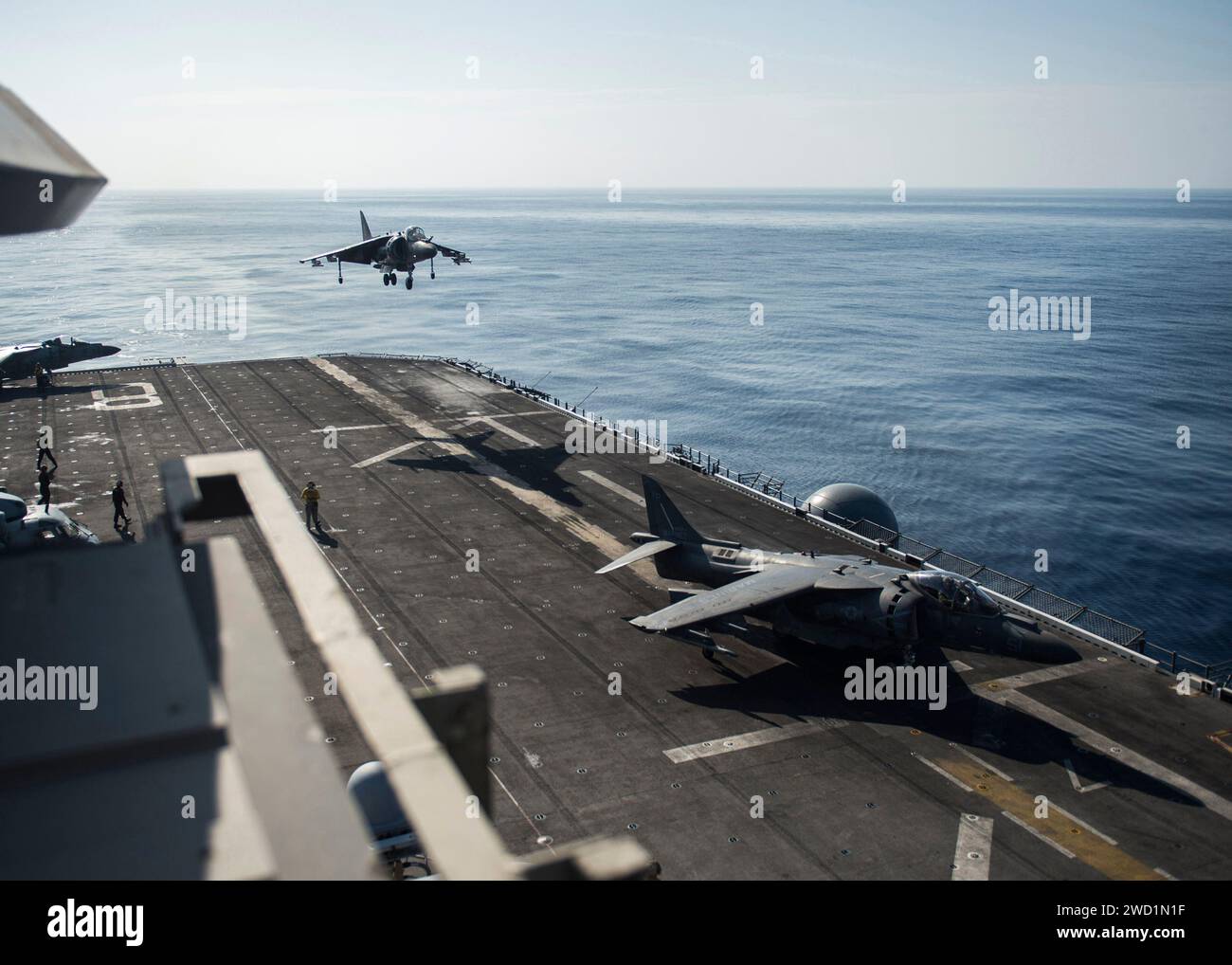 An AV-8B Harrier lands on the flight deck of USS Makin Island Stock ...