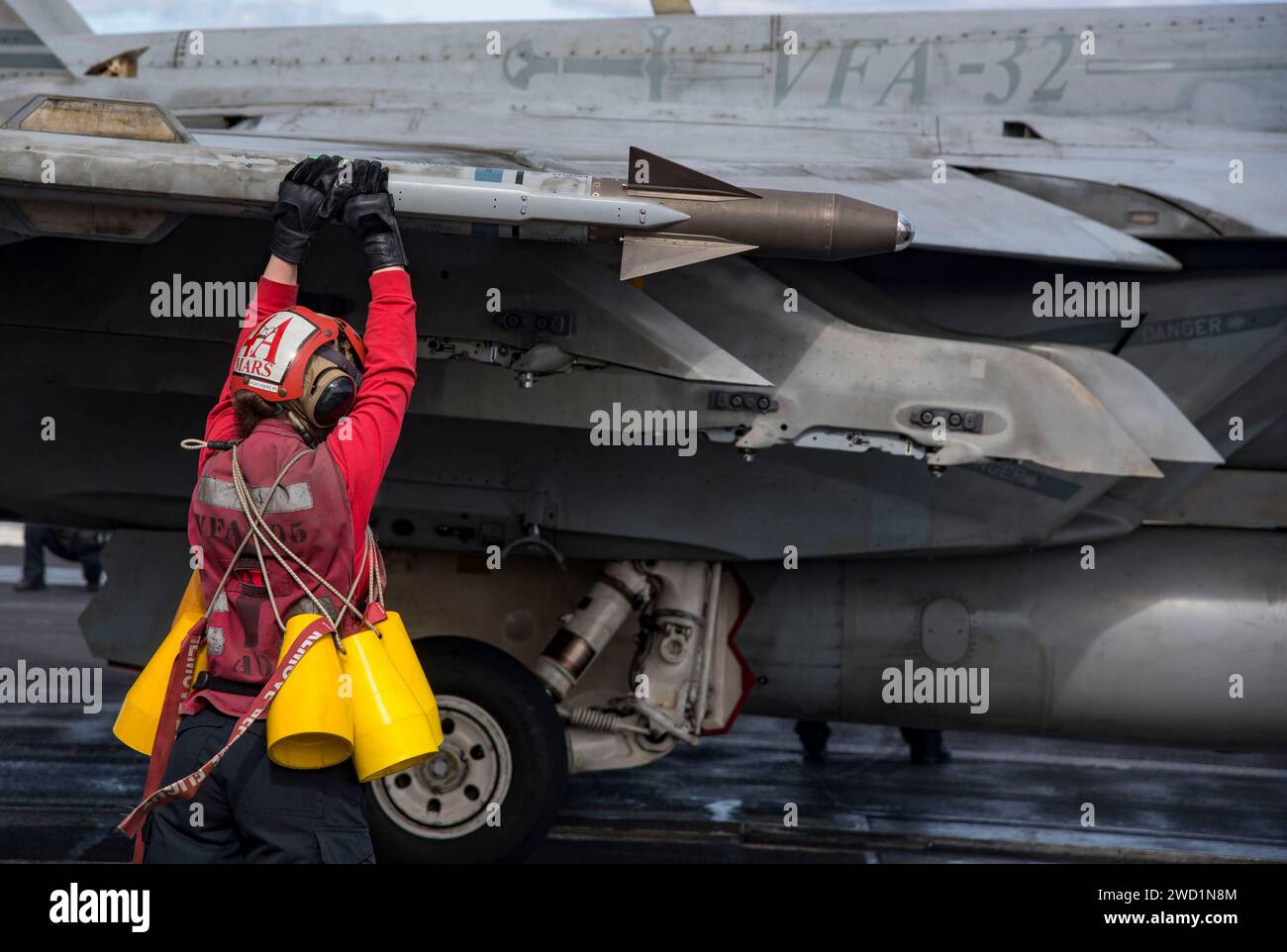 Aviation Ordnanceman arms ordnance on an F/A-18 Super Hornet Stock ...