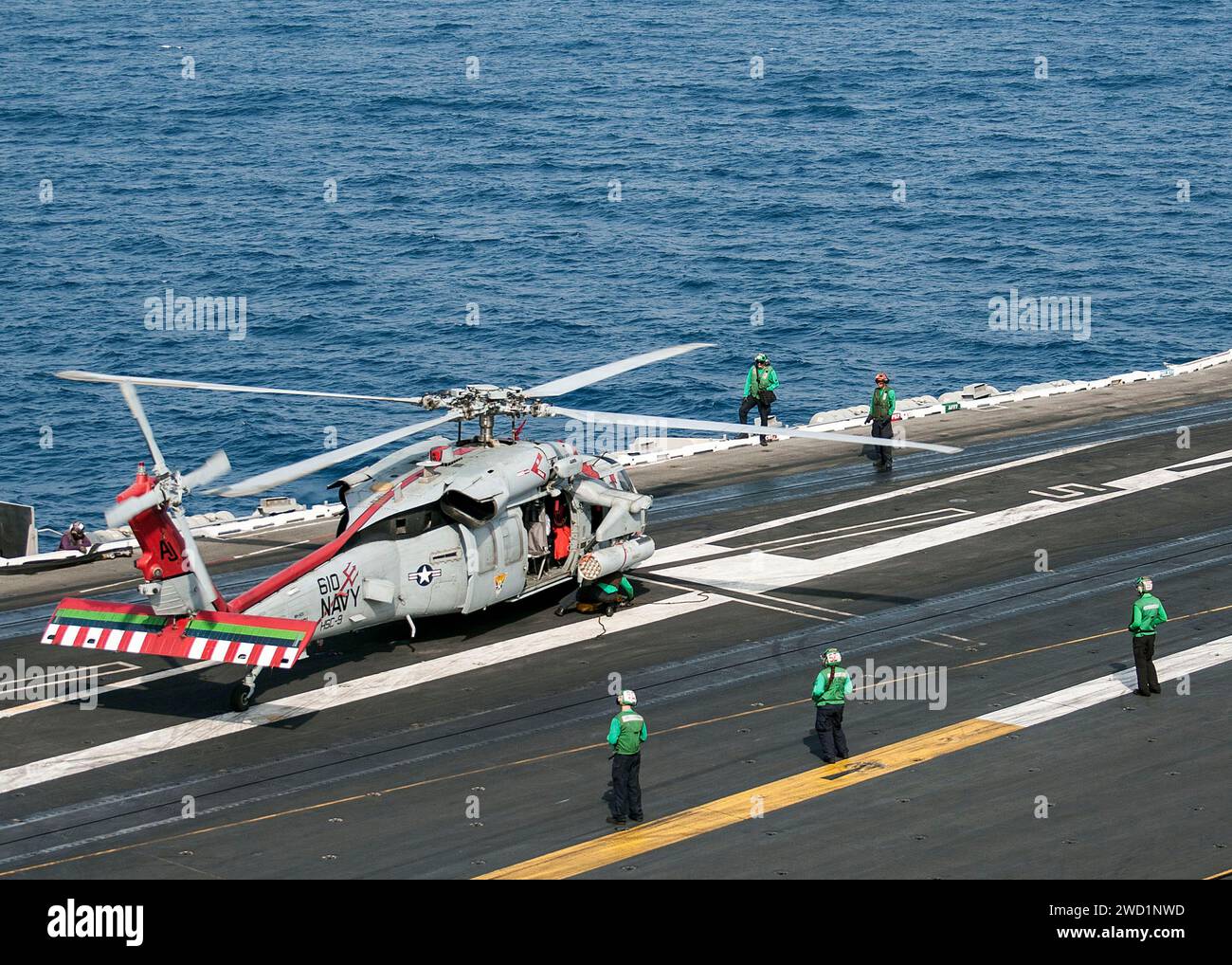 An MH-60S Sea Hawk lands aboard the aircraft carrier USS George H.W ...