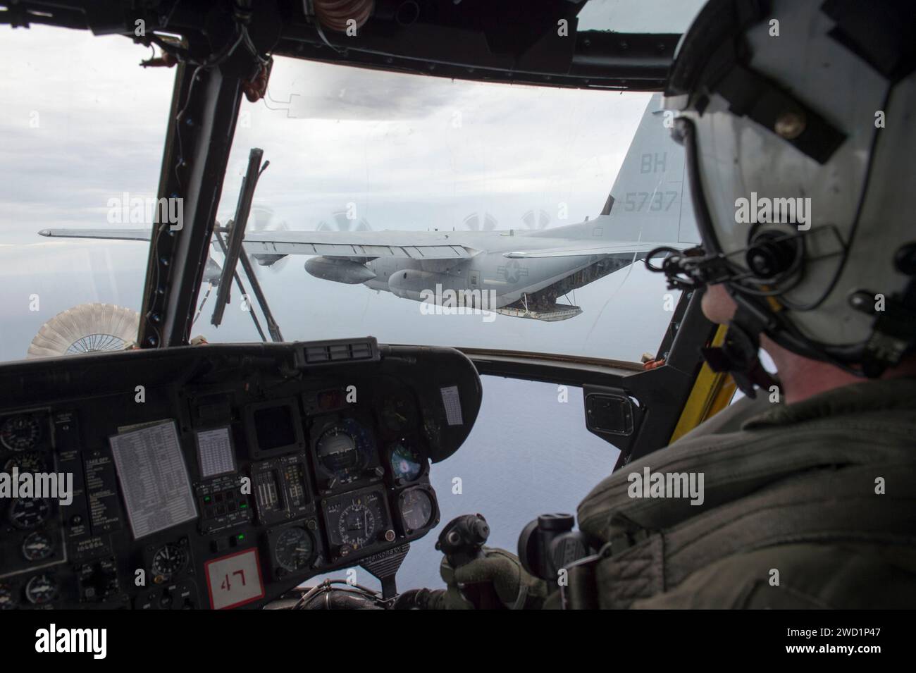 An MH-53E Sea Dragon helicopter conducts an inflight refueling with a ...