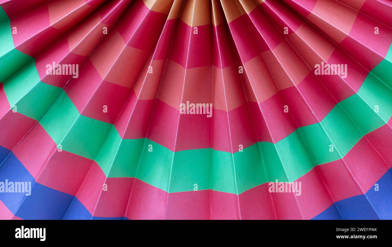 close-up of coloured paper pleated in a circle. Party decoration Stock ...