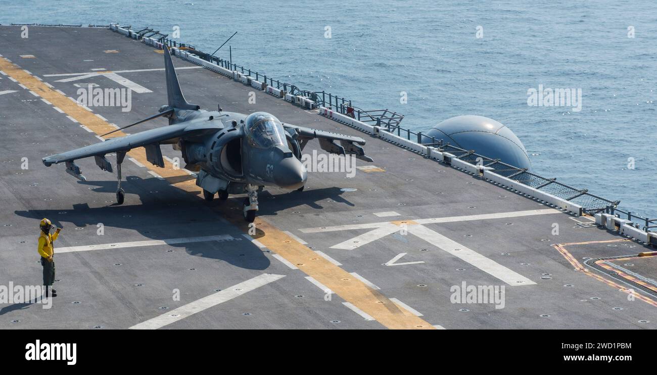 An AV-8B Harrier prepares to take off from the amphibious assault ship ...