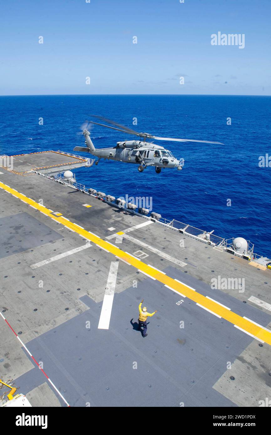 An MH-60S Sea Hawk helicopter takes off from the flight deck of USS ...