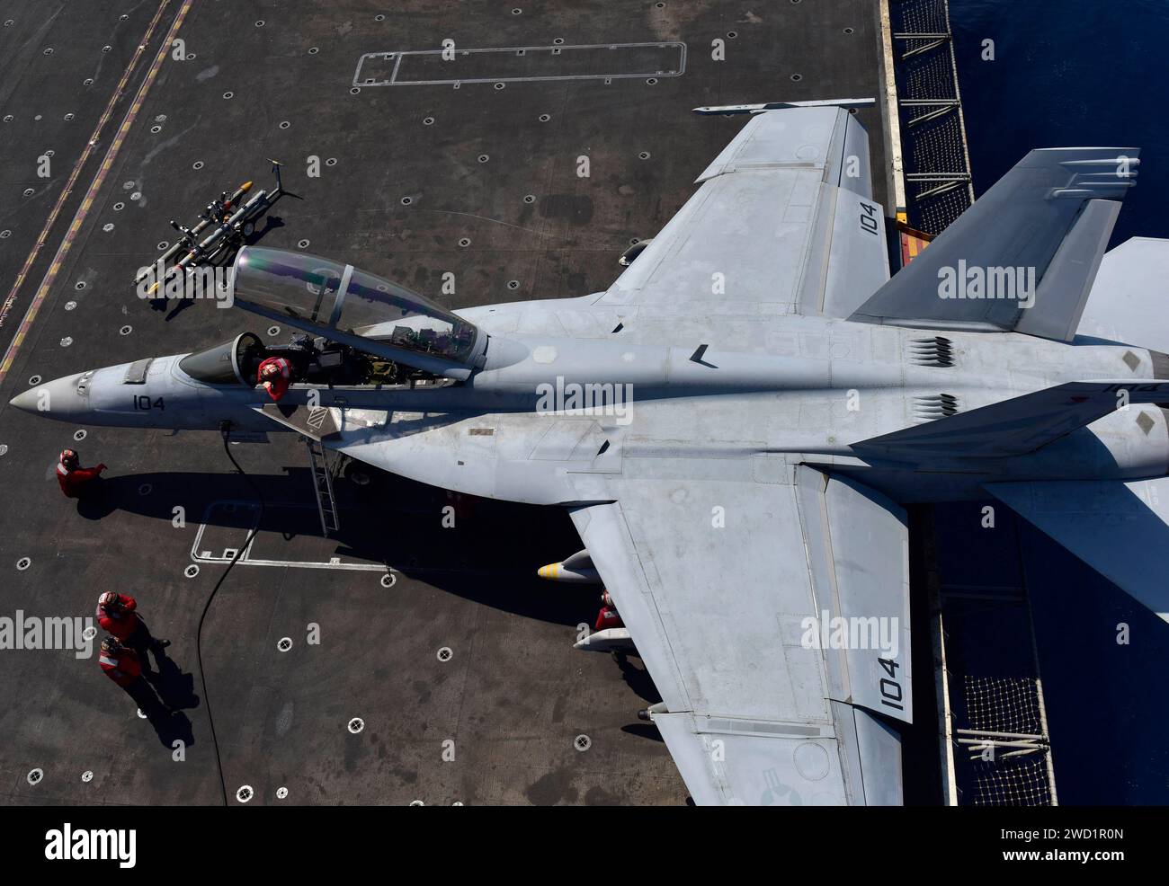 Sailors perform pre-flight checks on an F/A-18F Super Hornet aboard USS ...