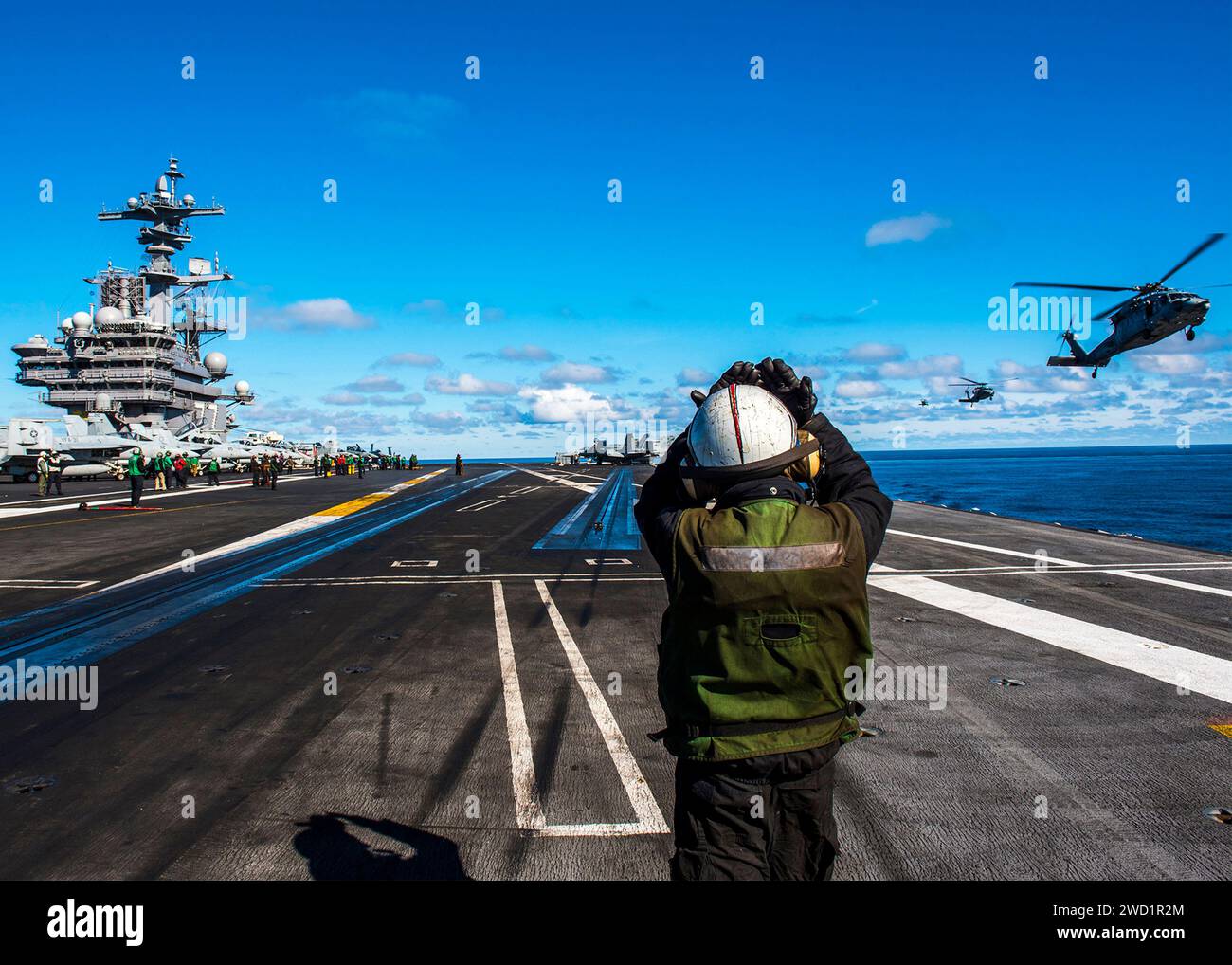 Sailors aboard the Nimitz-class aircraft carrier USS George H.W. Bush ...