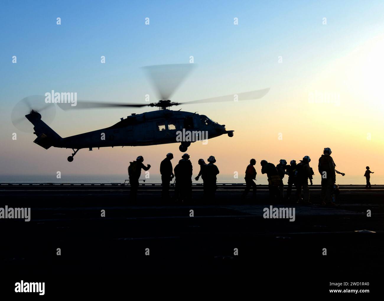 An MH-60S Sea Hawk helicopter prepares to land aboard the aircraft ...