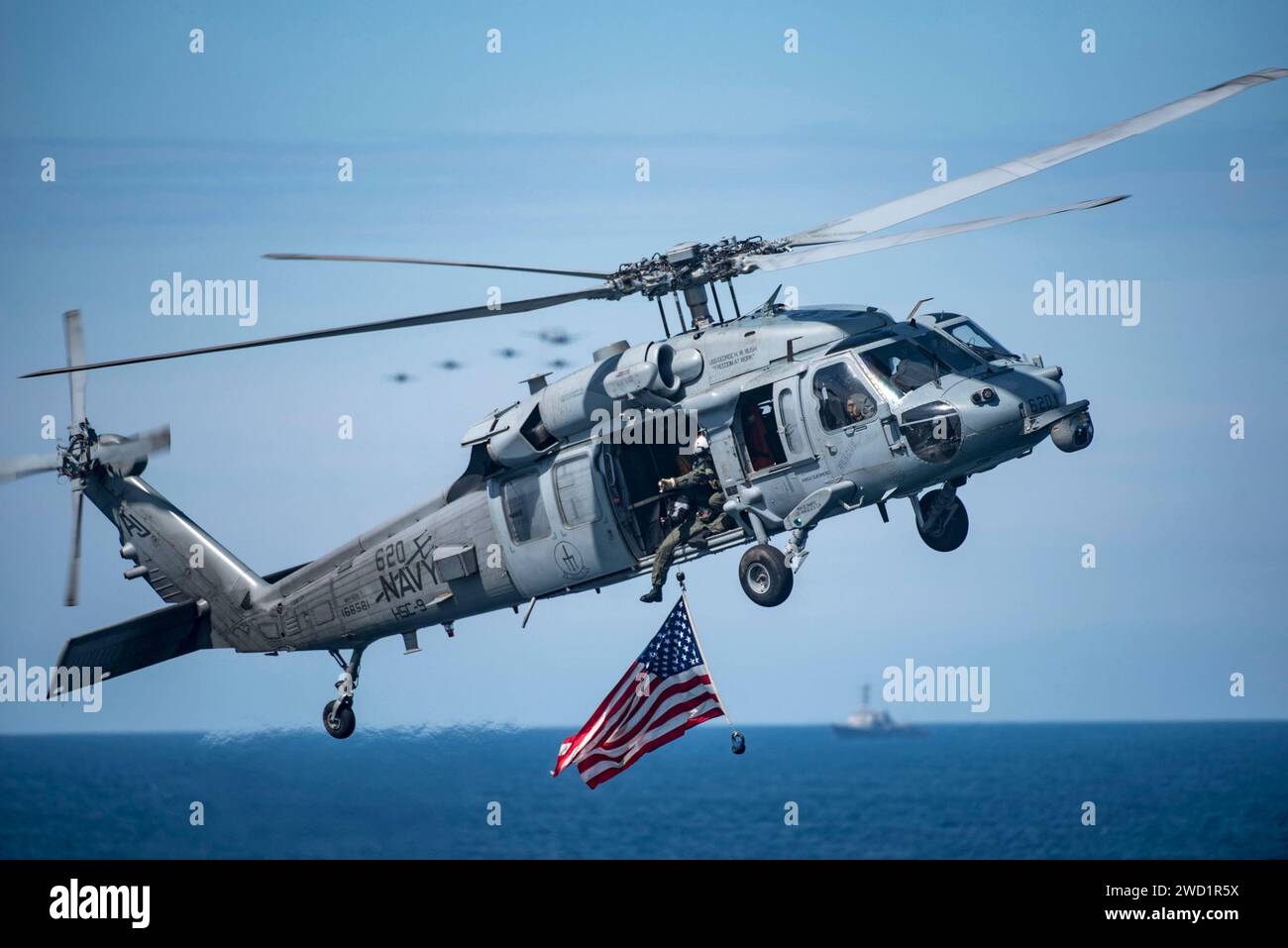 An MH-60S Sea Hawk helicopter displays the American flag Stock Photo ...