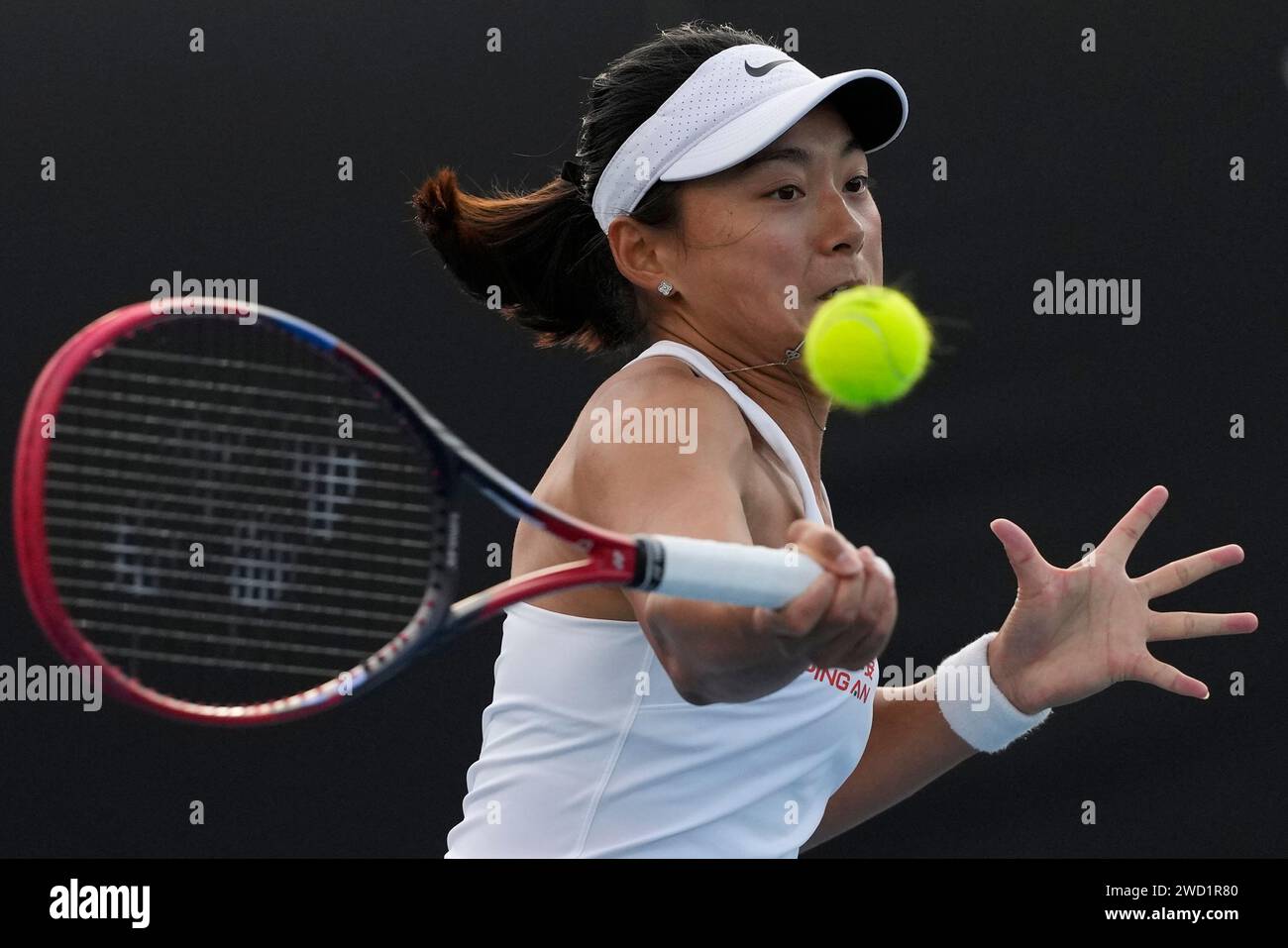 Wang Yafan of China plays a forehand return to Emma Raducanu of Britain ...