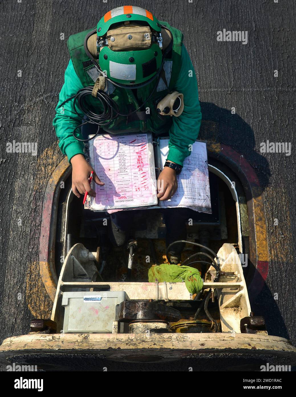 Airman checks the catapult three rundown log on the flight deck of USS ...