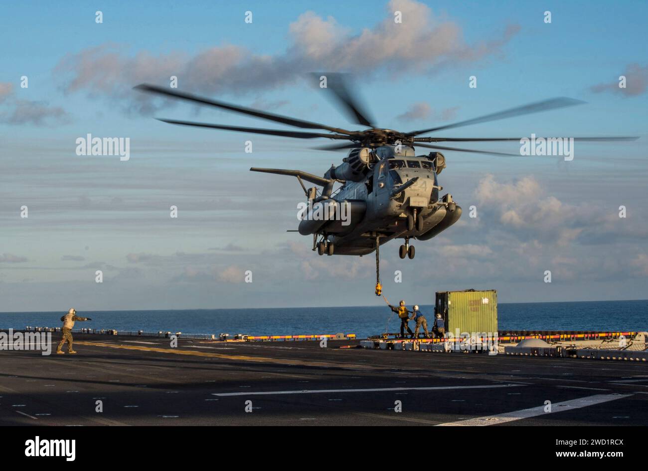 U.S. Marines hook cargo to a CH-53E Super Stallion helicopter on the ...