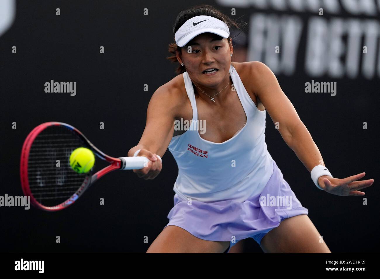 Wang Yafan of China plays a forehand return to Emma Raducanu of Britain ...