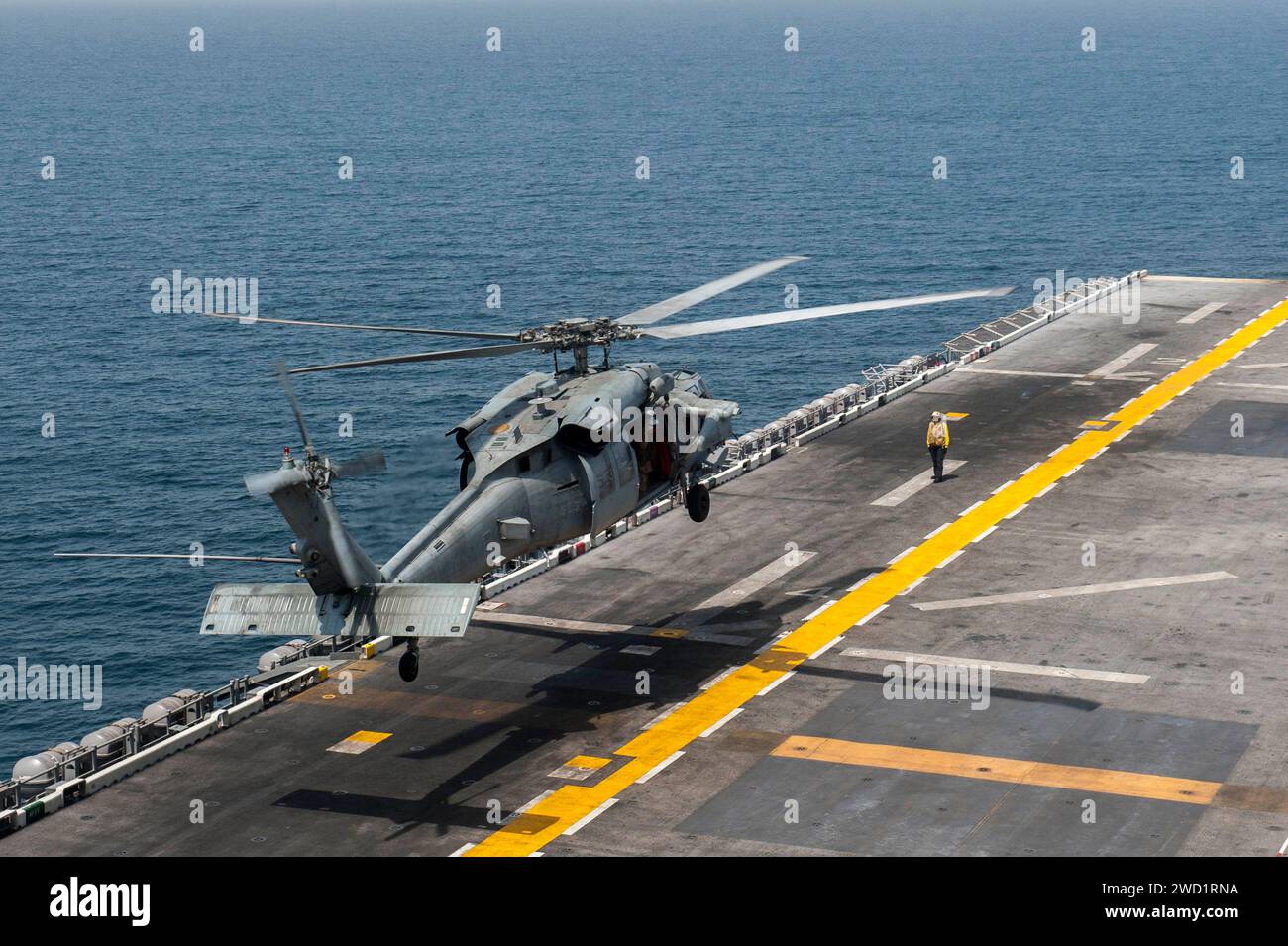 An MH-60S Sea Hawk helicopter lifts off from the flight deck of USS ...