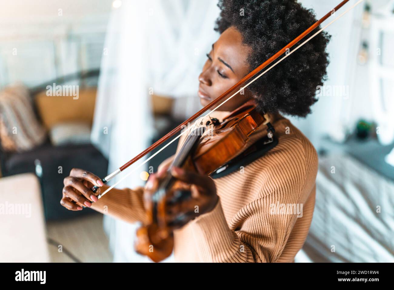 Attractive young african american woman musician plays the violin ...