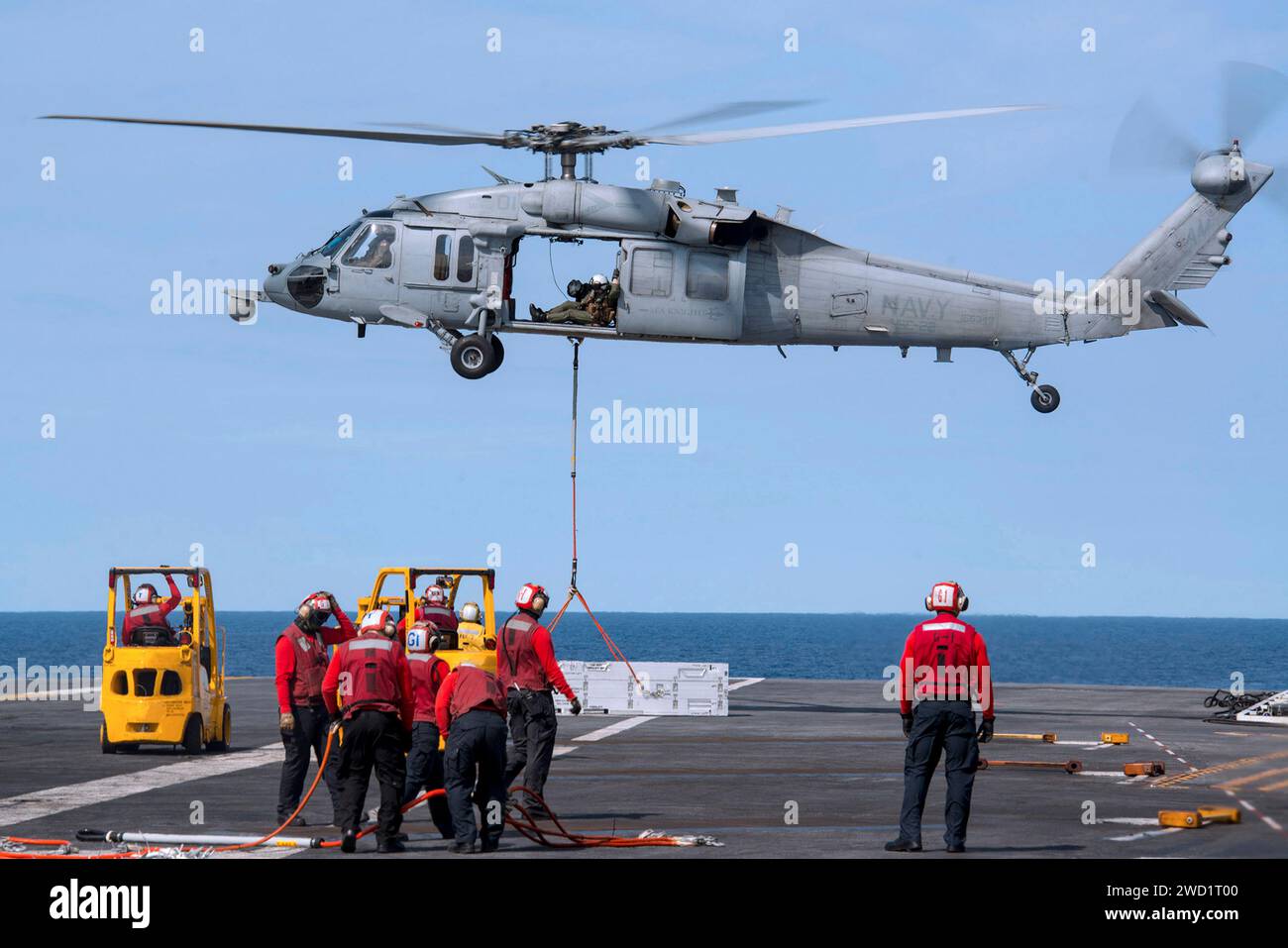A military helicopter conducts an ammunition onload between U.S. Navy ...
