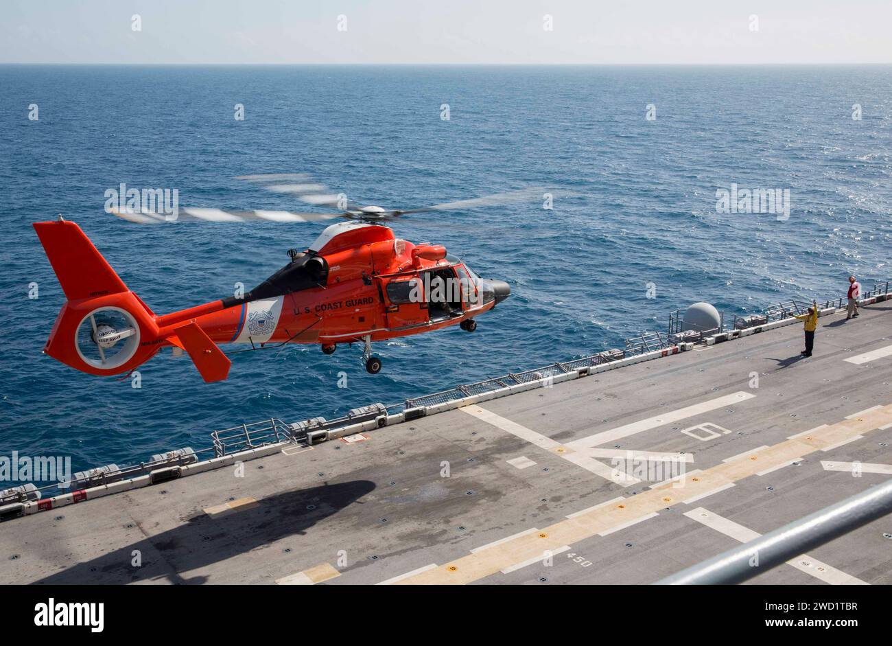 A U.S. Coast Guard MH-60 Dolphin helicopter takes off after refueling ...