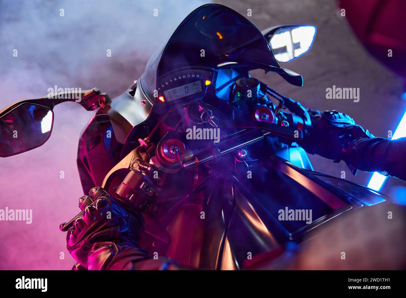 Closeup view of motorcycle dashboard in neon blue color illumination ...