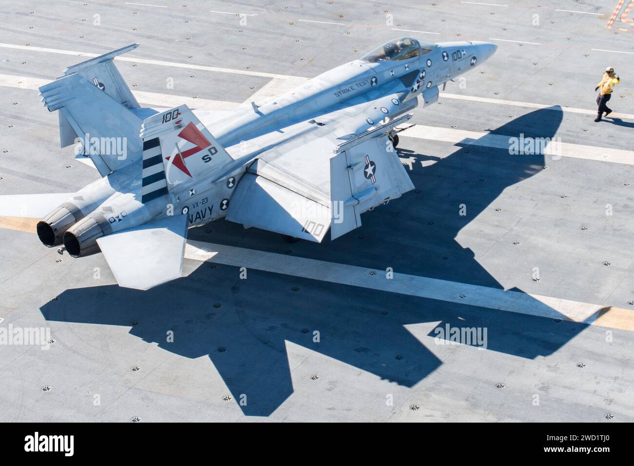 A sailor directs an aircraft across the flight deck of USS Gerald R ...
