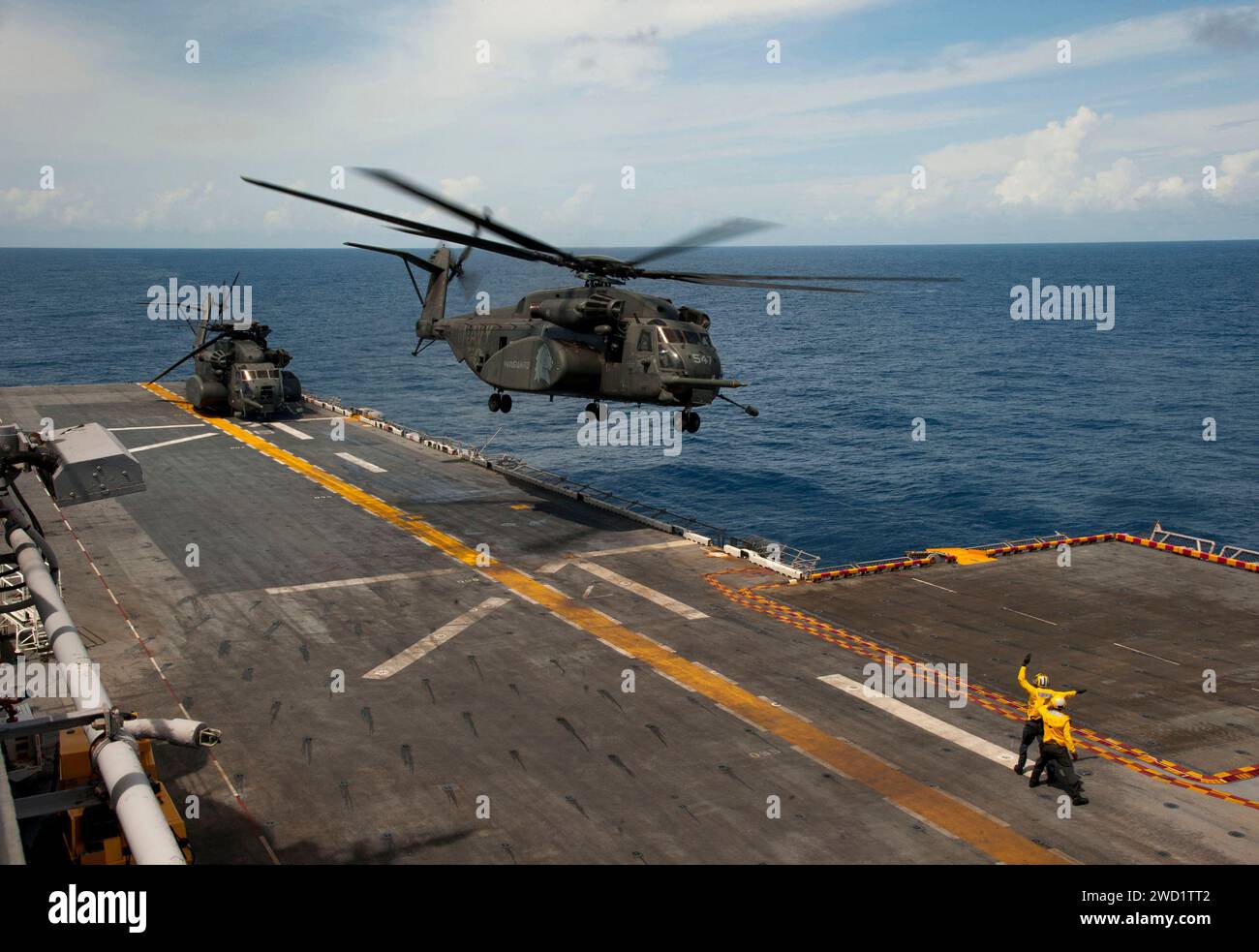 An MH-53E Sea Dragon helicopter takes off of the flight deck of USS ...