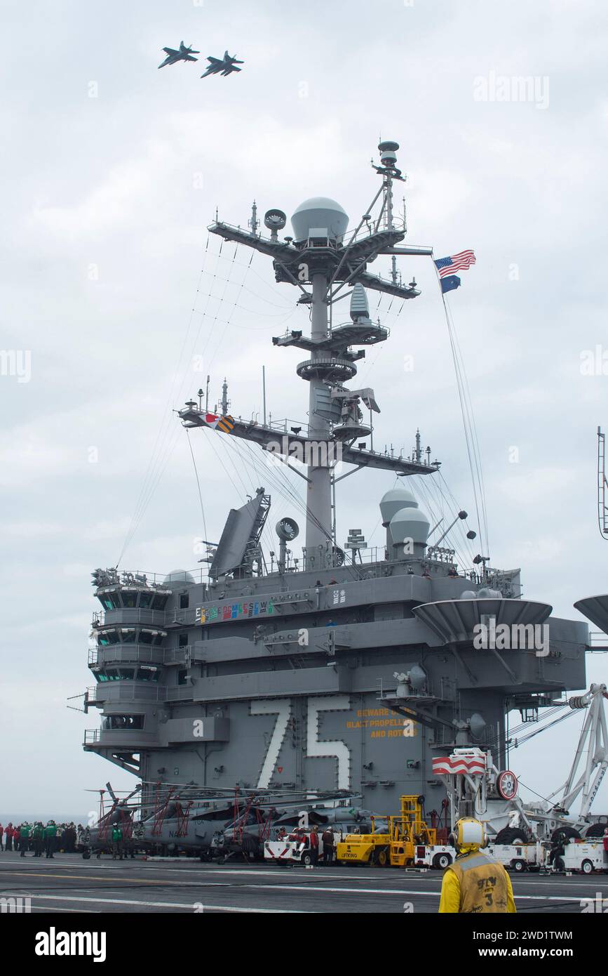 Aircraft fly over the aircraft carrier USS Harry S. Truman during ...