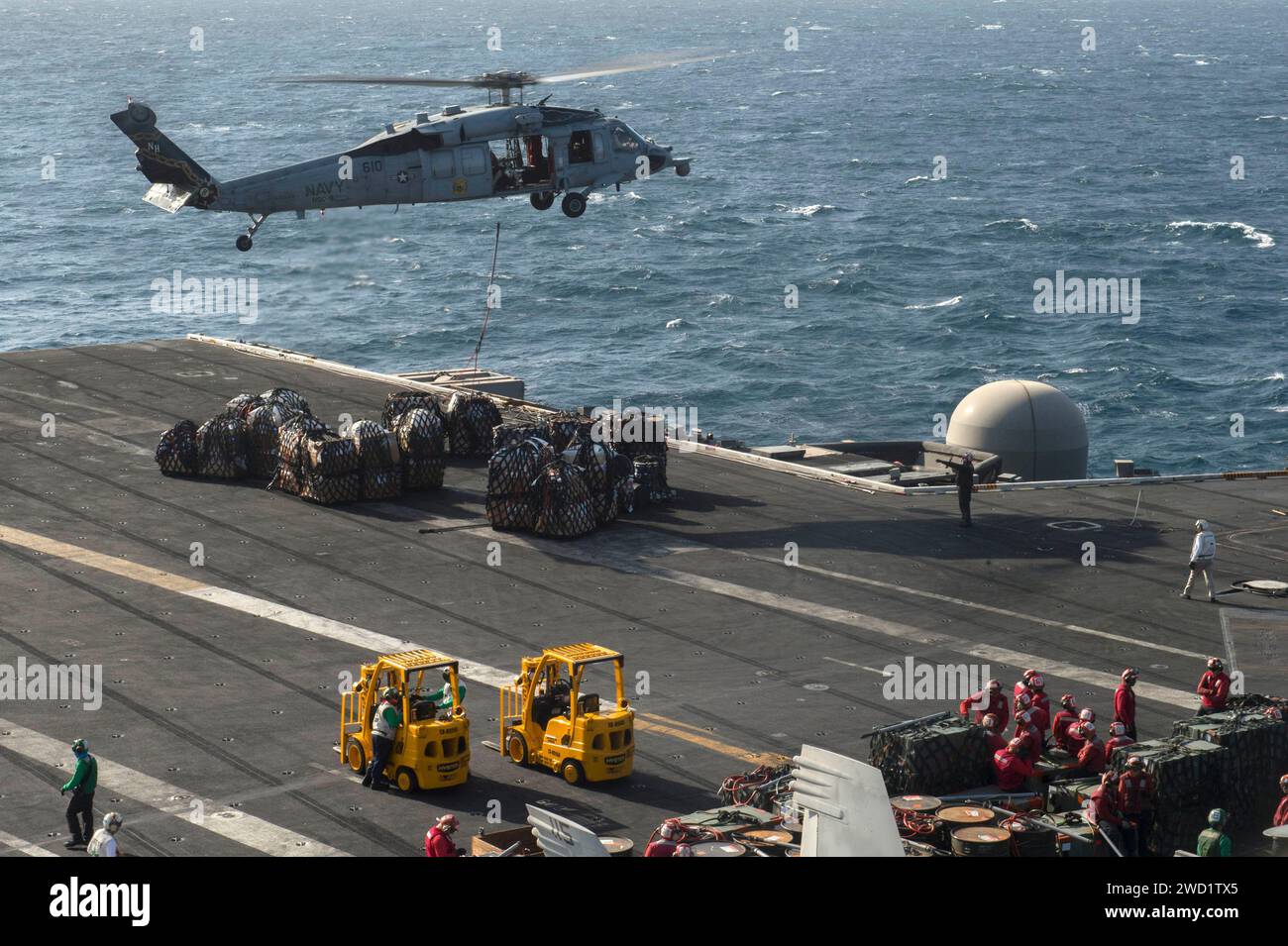 An MH-60S Sea Hawk helicopter transports supplies to the aircraft ...