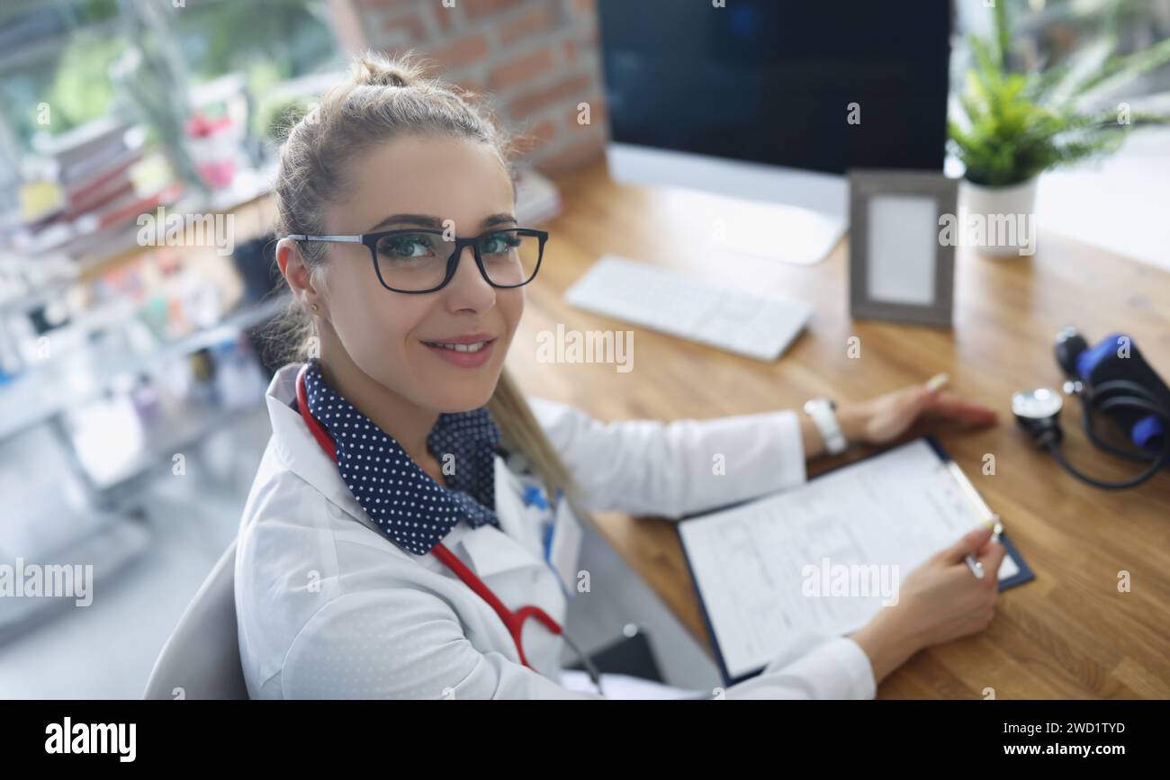 Doctor fill in patients medical history, stethoscope on neck, modern ...
