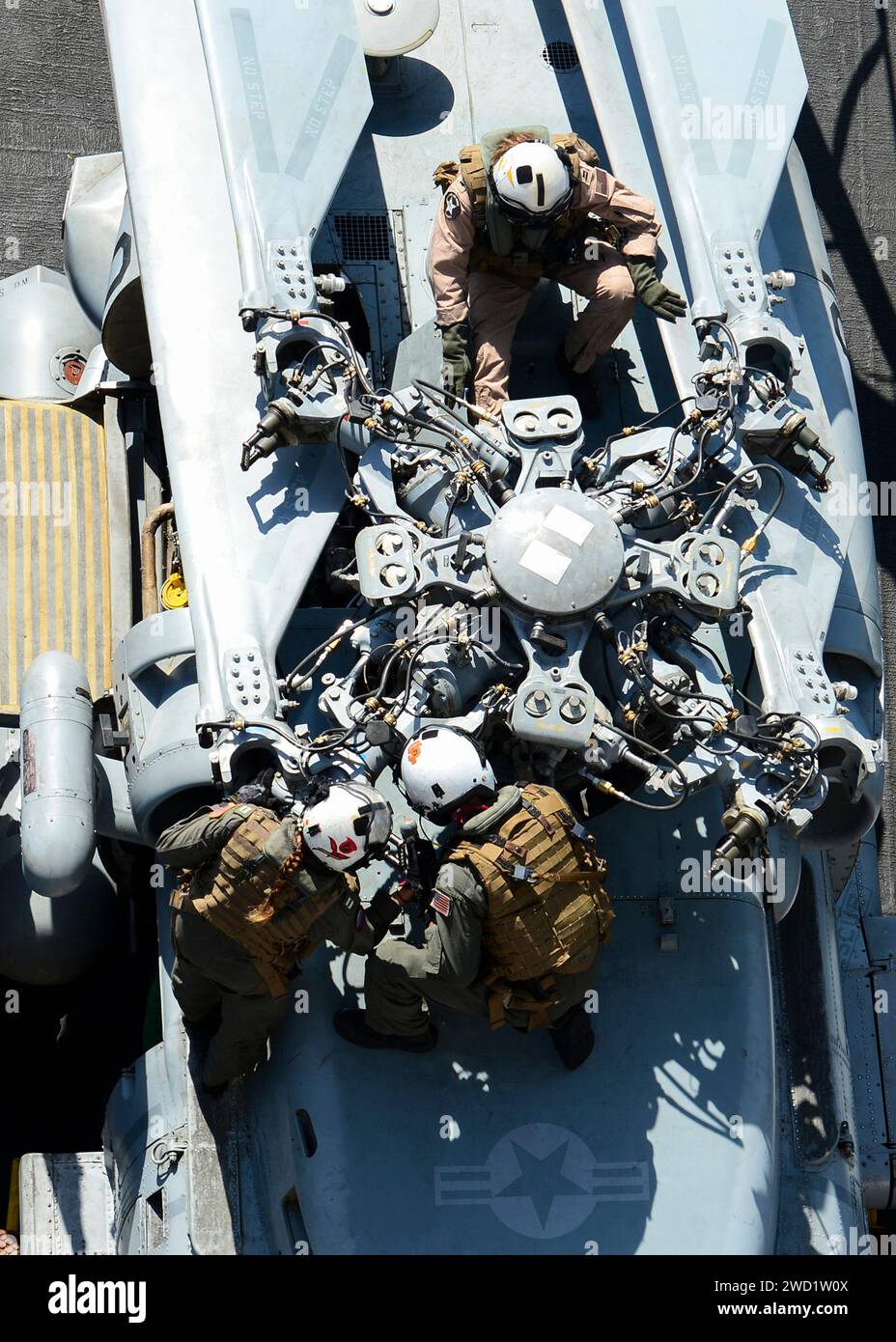 Sailors conduct a pre-flight check on an MH-60R Sea Hawk helicopter ...