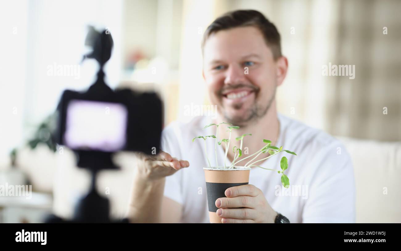 Middle aged man recording on video how he growing plants at home Stock ...