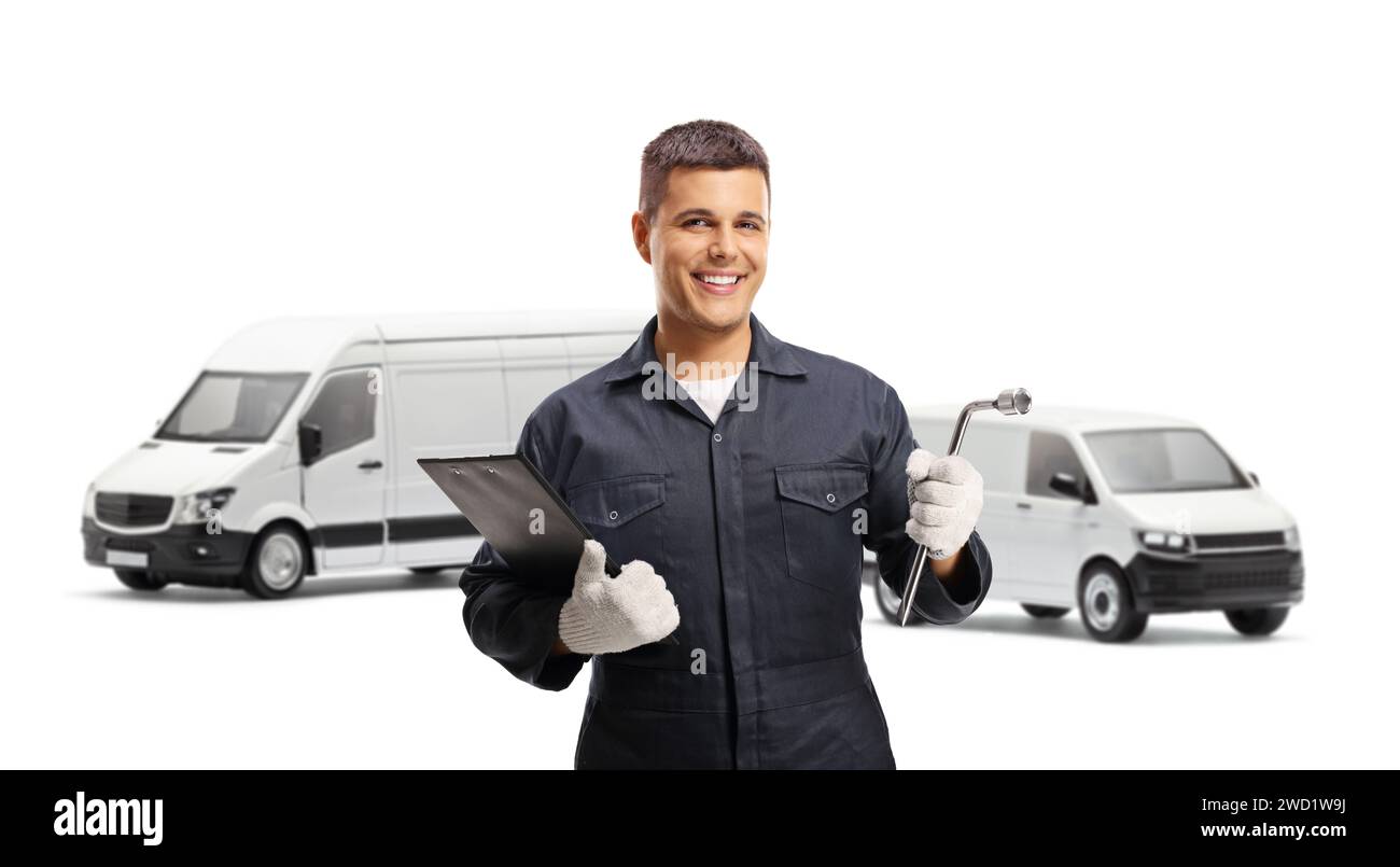 Car repair worker holding tools near vans isolated on white background ...