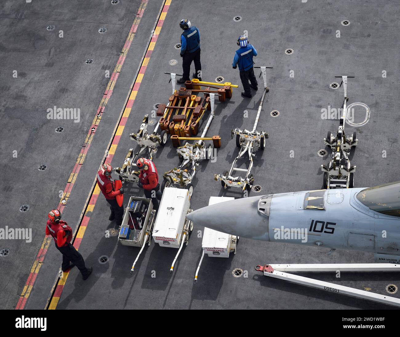 Sailors organize ordnance on the flight deck of USS Carl Vinson Stock ...