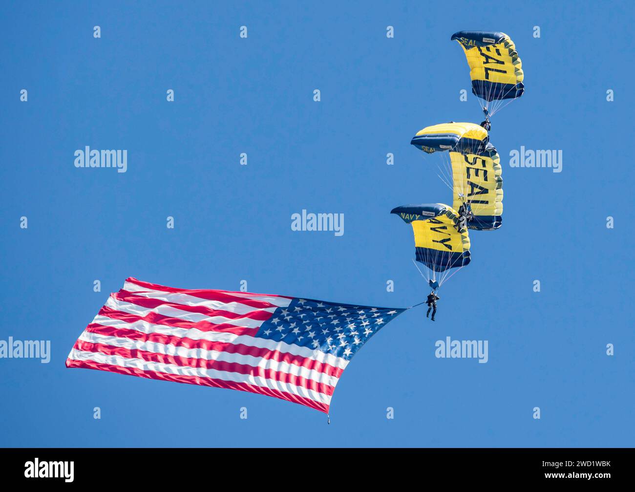 Members of the U.S. Navy parachute team, the Leap Frogs, build a ...