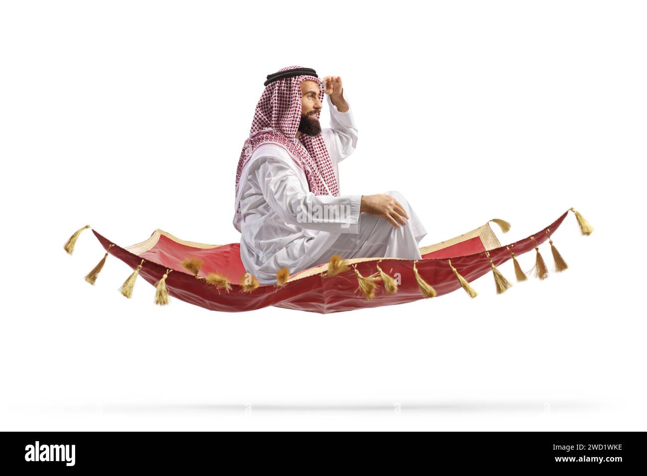 Profile shot of a saudi arab man sitting on a magic carpet and flying ...