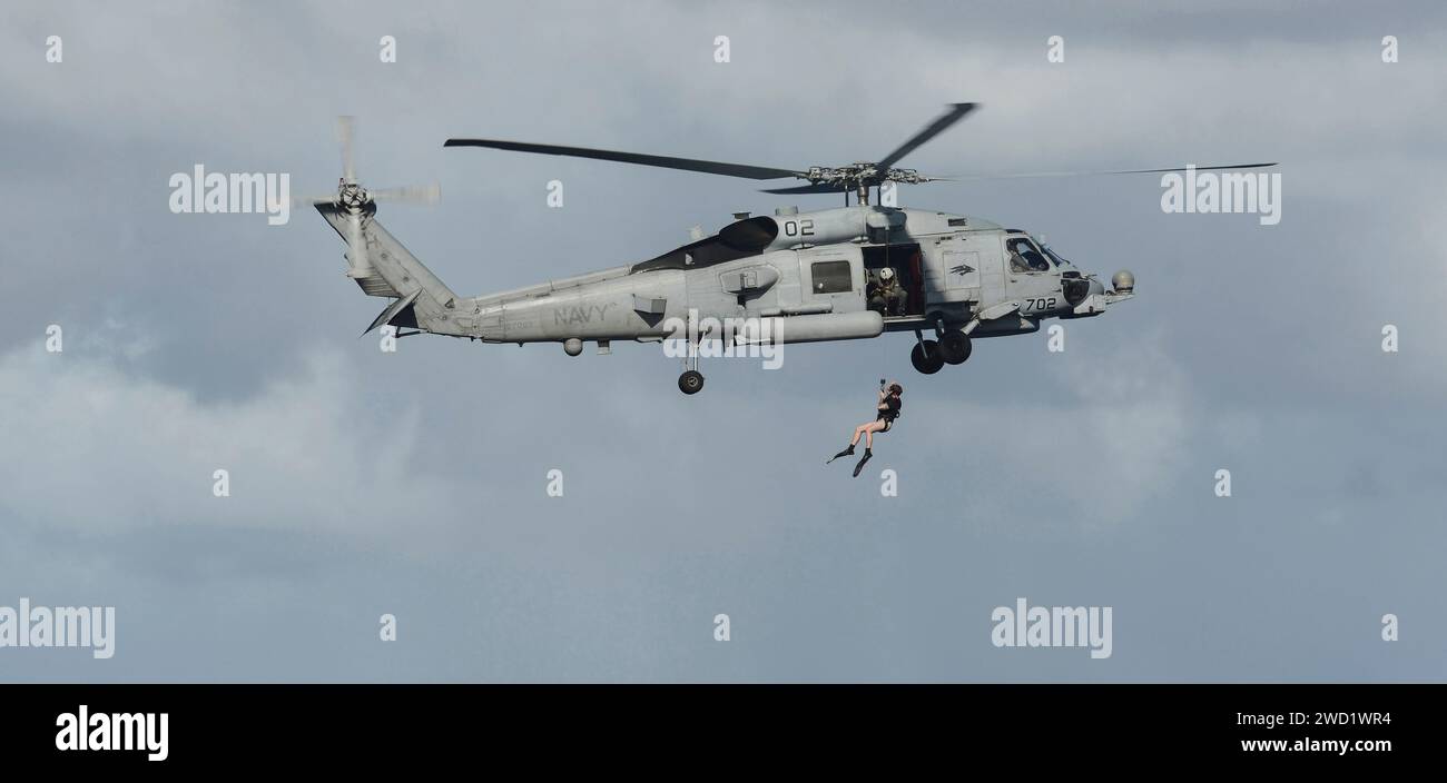 Sailors demonstrate rescue swimmer operations from an MH-60R Sea Hawk ...