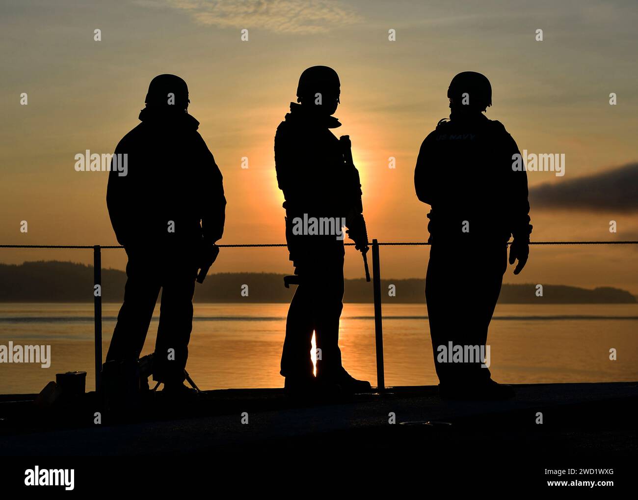 Sailors man a security watch aboard the aircraft carrier USS Nimitz ...