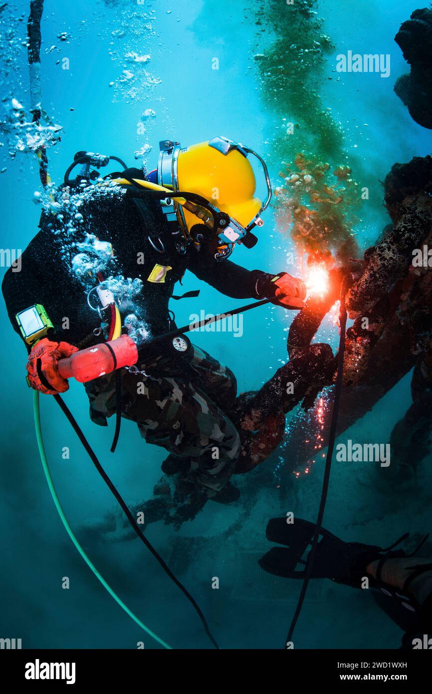 U.S. Navy Diver performs underwater cutting operations using a Broco ...