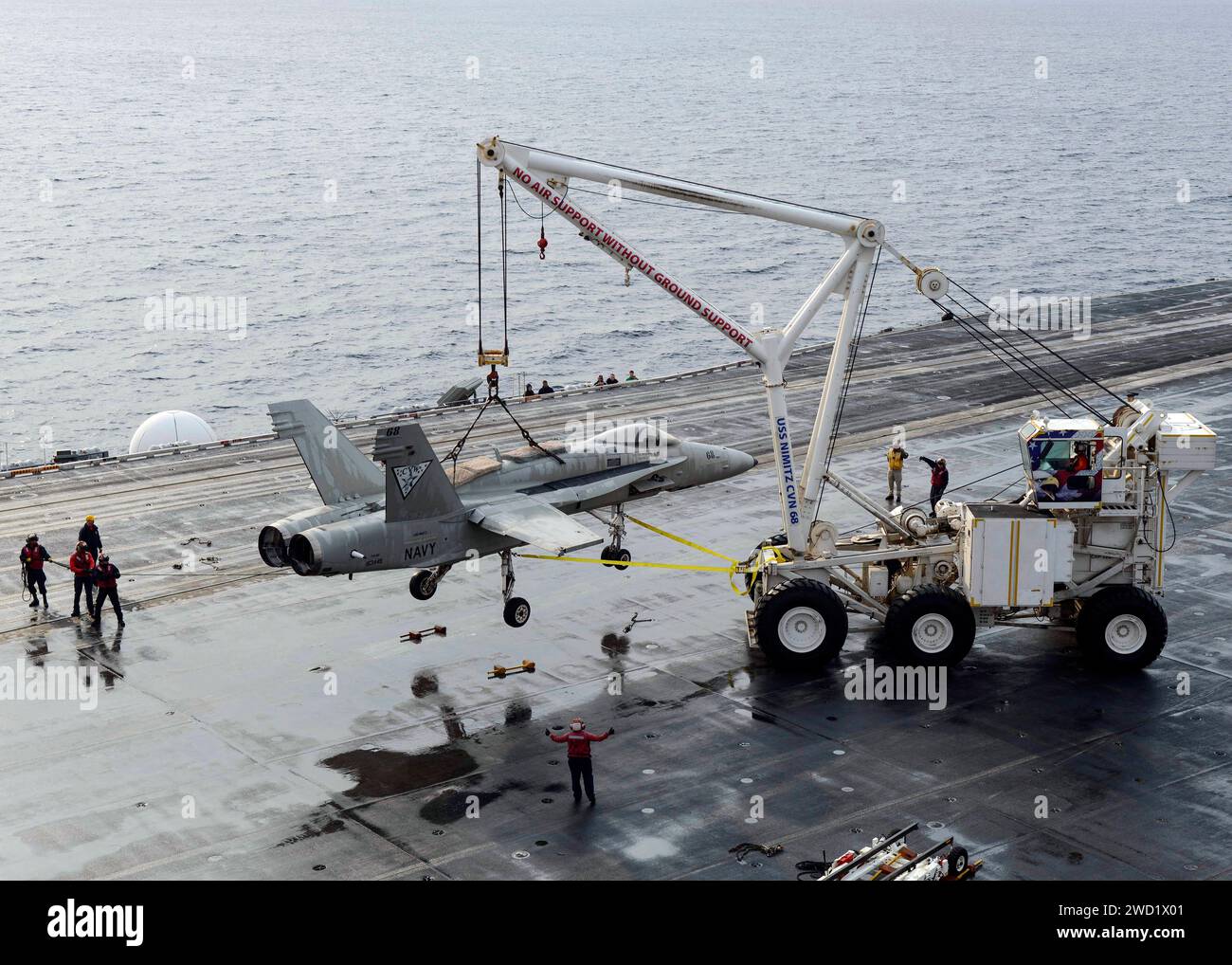 U.S. Navy Sailors demonstrate the operation of the mobile crash crane ...