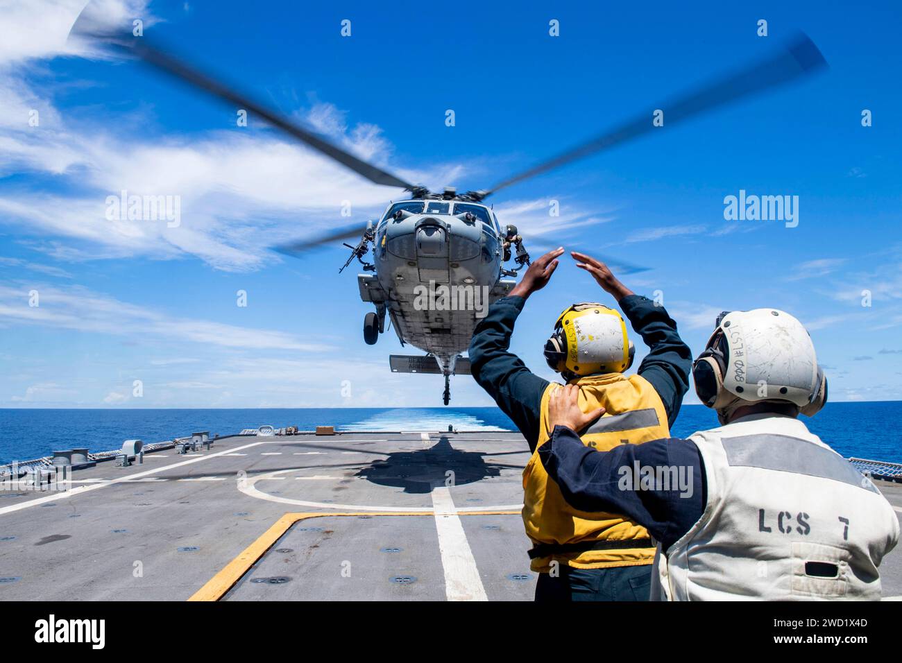 An MH-60R Sea Hawk helicopter takes off from the flight deck of USS ...