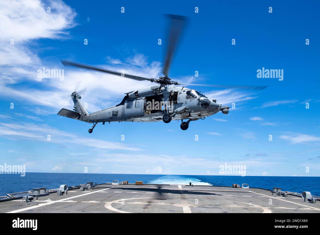 An MH-60R Sea Hawk helicopter takes off from the flight deck of USS ...