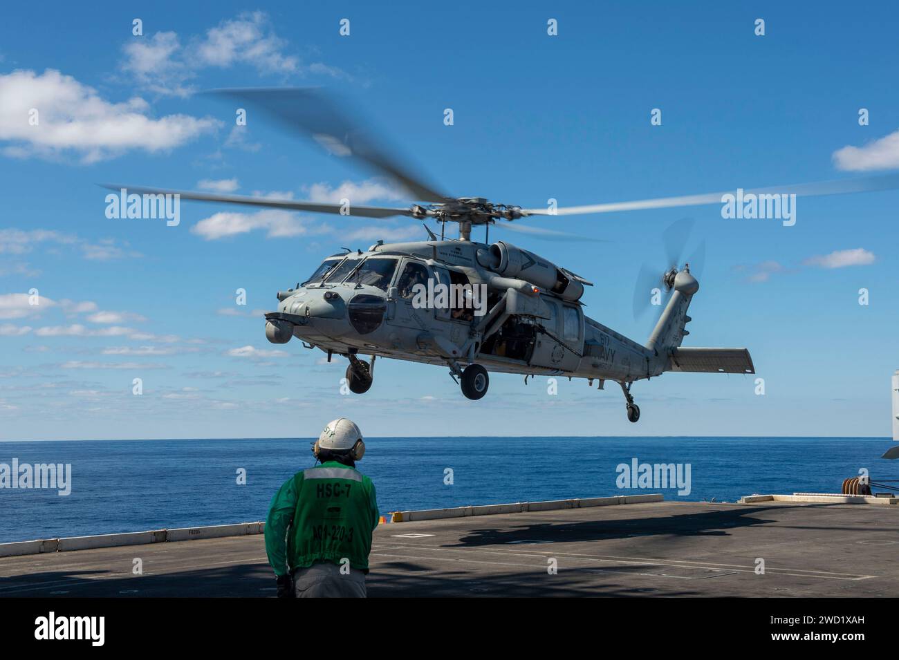 An MH-60S Sea Hawk helicopter lands on the flight deck aboard USS ...